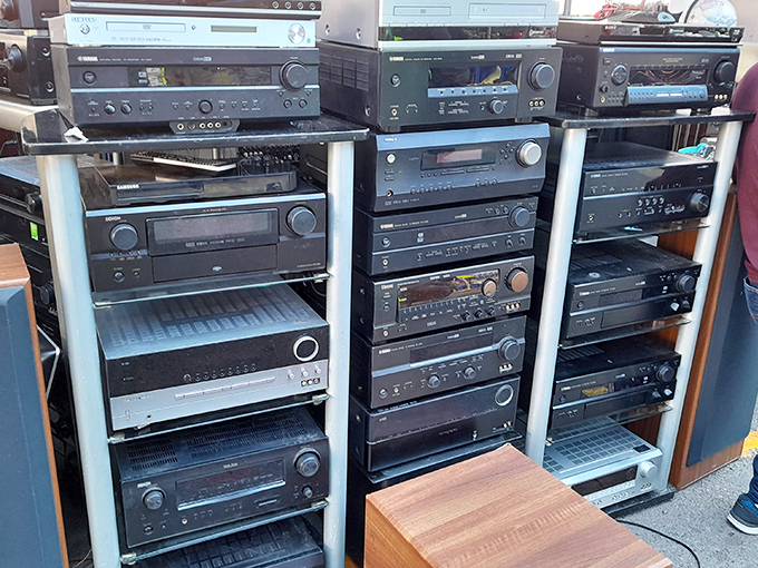 Vintage audio equipment stacked like a time machine of sound. These receivers and amplifiers witnessed the golden age of vinyl.