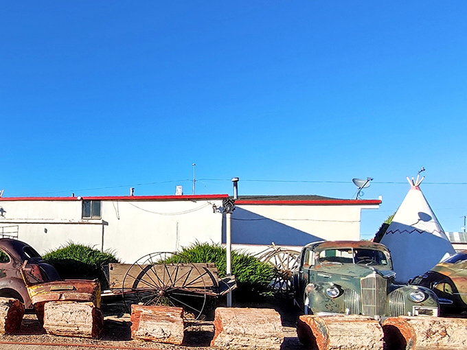 Behind the scenes, vintage cars and rustic props create an outdoor museum of Americana.