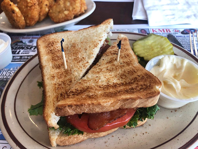 The classic club sandwich – where bread, meat, and vegetables come together in a stack so perfect it should require an engineering permit.
