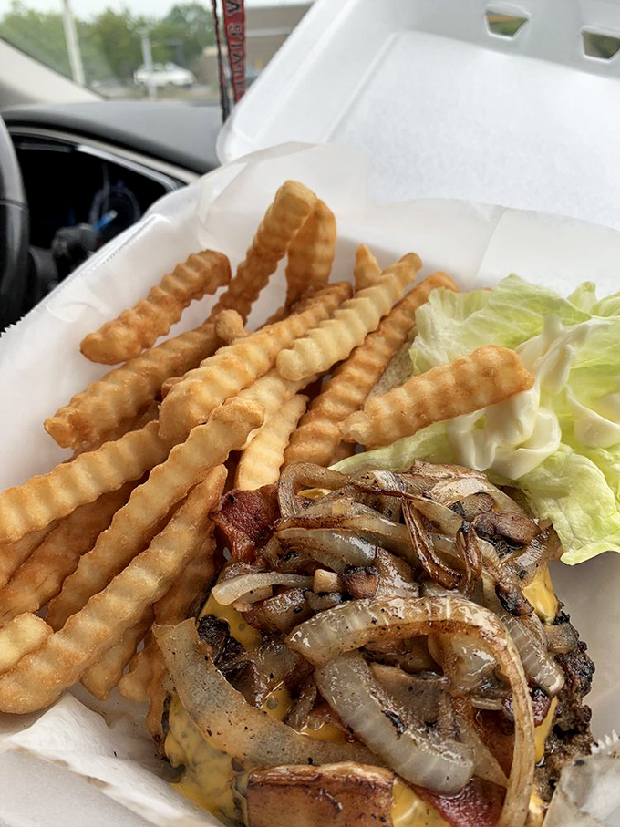 This bacon cheeseburger with grilled onions isn't just lunch&mdash;it's therapy on a bun. The fries standing at attention know they're in the presence of greatness.