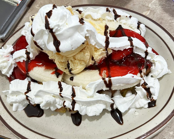 This banana split isn't dessert; it's performance art with whipped cream. A symphony of textures that makes adults remember the joy of being kids.
