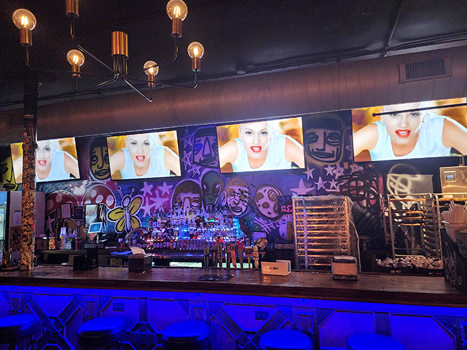 The bar area pops with neon blue light and street art vibes&mdash;a visual amuse-bouche before the main pizza event.