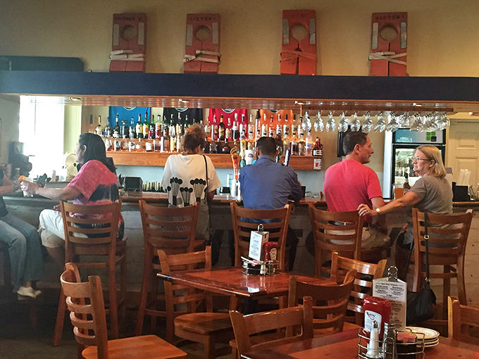 The bar isn't just serving drinks; it's dispensing liquid sunshine and vacation vibes to a crowd that knows the value of both.