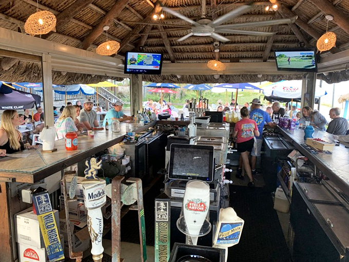 The tiki-style bar serves tropical dreams under woven lights, where every drink tells a story.