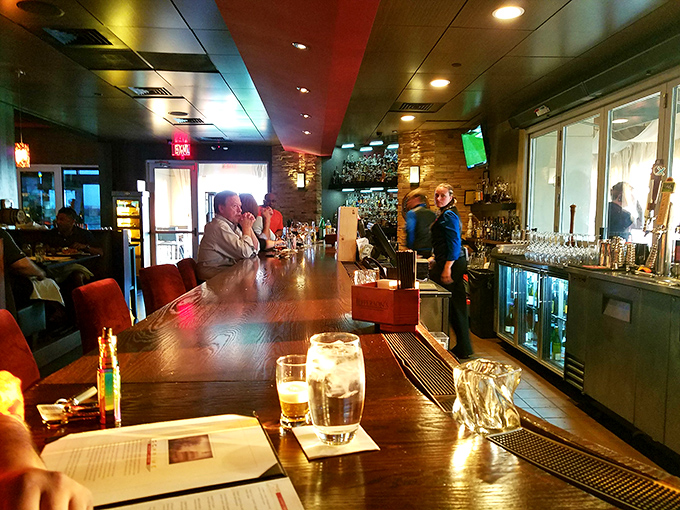 The bar: where solo diners become regulars and strangers become friends over perfectly crafted cocktails and shared food recommendations.