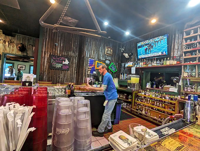The bar area's corrugated metal walls and mounted deer heads create that perfect blend of rustic charm and "I might be in a Western movie."