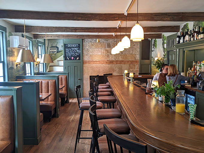 Polished wood and warm tones create a bar atmosphere that invites you to linger over well-made cocktails.