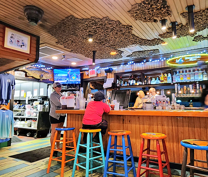The bar area: where colorful stools invite you to perch like exotic birds while watching the bartenders work their magic.