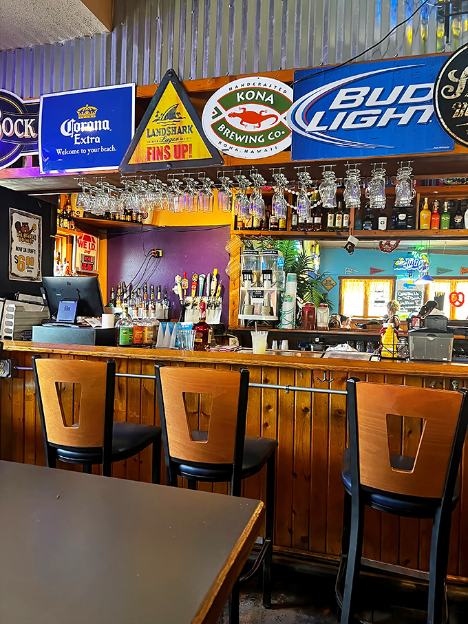 The bar area strikes that perfect balance between dive bar authenticity and vacation vibes&mdash;where beer signs glow like beacons and glasses hang ready for the next pour.