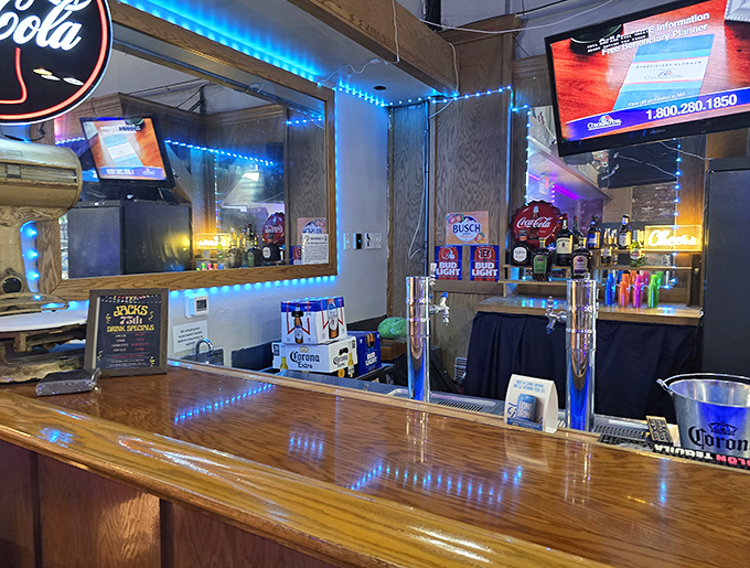 The bar's blue neon glow creates the perfect backdrop for cold beer and hot pizza conversations that stretch into the evening.