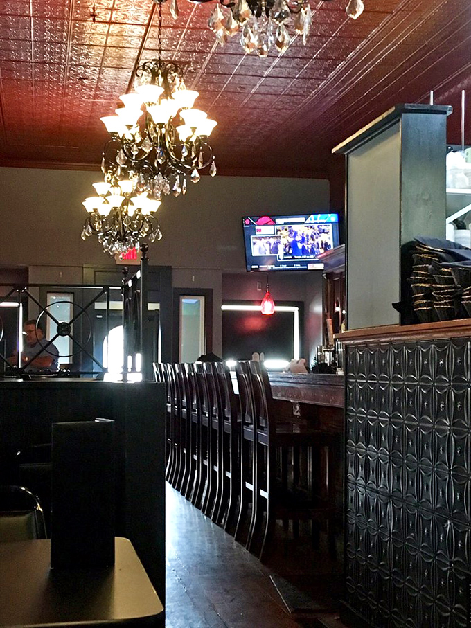 Crystal chandeliers above a meticulously designed bar area create an atmosphere that whispers "special occasion" even on an ordinary Tuesday.