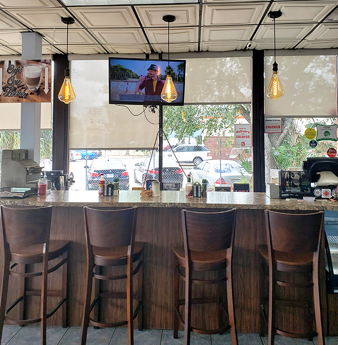 Bar seating where coffee refills flow freely and you can watch short-order magic happen in real time. 