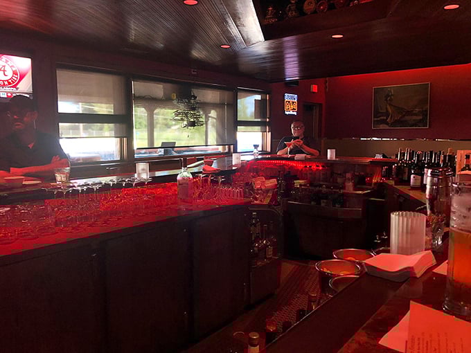 The bar glows red like the beating heart of the establishment. This is where friendships are forged and the evening's first stories are shared.