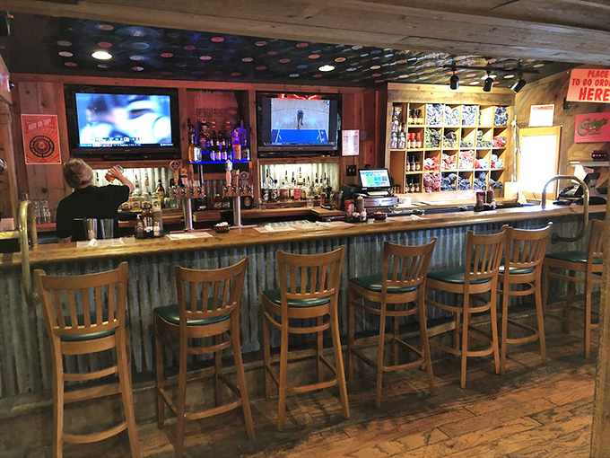 The bar area where barbecue pilgrims gather to share stories and sauce preferences. Wood, corrugated metal, and cold drinks&mdash;the holy trinity of barbecue ambiance.