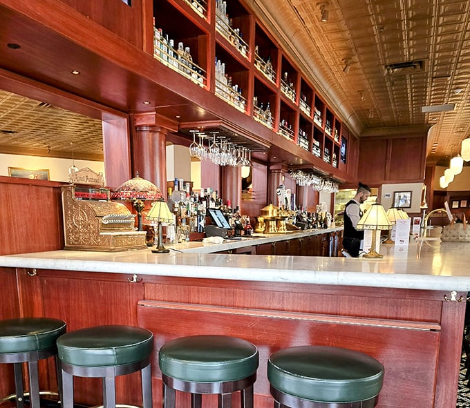 The bar gleams with promise, its rich mahogany shelves and vintage-style lamps suggesting this is where civilized adults come to unwind properly.