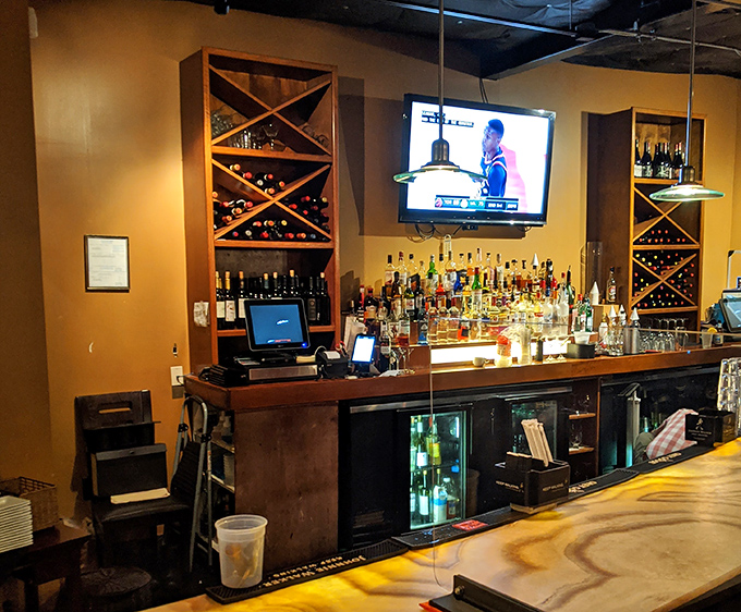 A bar stocked for serious business, with wooden wine racks that suggest they take your evening libation choices as seriously as their food.