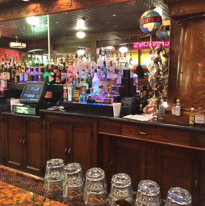 The bar gleams with bottles backlit like Broadway stars, promising libations that pair perfectly with stories shared among friends.