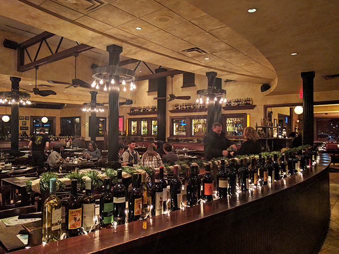 The bar showcases bottles like trophies, each one promising a different Italian adventure without the airfare.