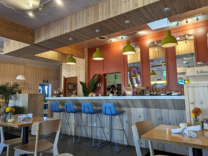 The counter where breakfast dreams become reality. Those blue bar stools have witnessed countless first sips of transformative coffee.