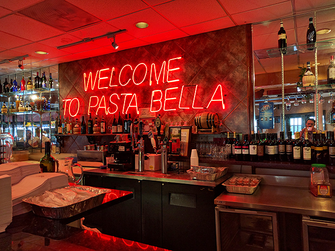 The neon "WELCOME TO PASTA BELLA" sign &ndash; hospitality in electric form. This bar area practically guarantees a good time is about to unfold.