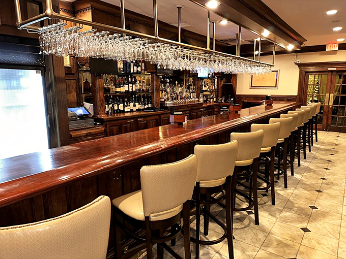 The bar stretches like a mahogany runway where cocktail dreams take flight nightly.