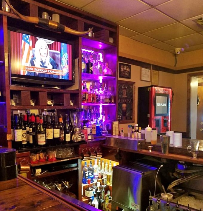 The bar area glows with promise—a beacon for those who believe a proper steak dinner begins with a properly made cocktail.