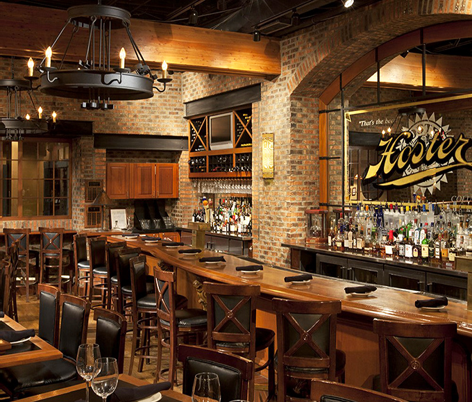 The bar at J. Gilbert's doesn't just serve drinks; it creates a sanctuary where bourbon flows and food envy happens when plates pass by.