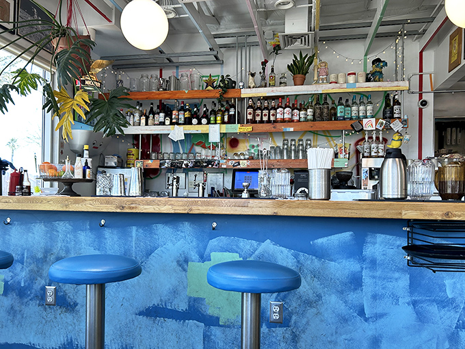 The bar's blue hues and carefully curated bottles promise cocktails that complement those biscuits like Sinatra complements a Vegas showroom.