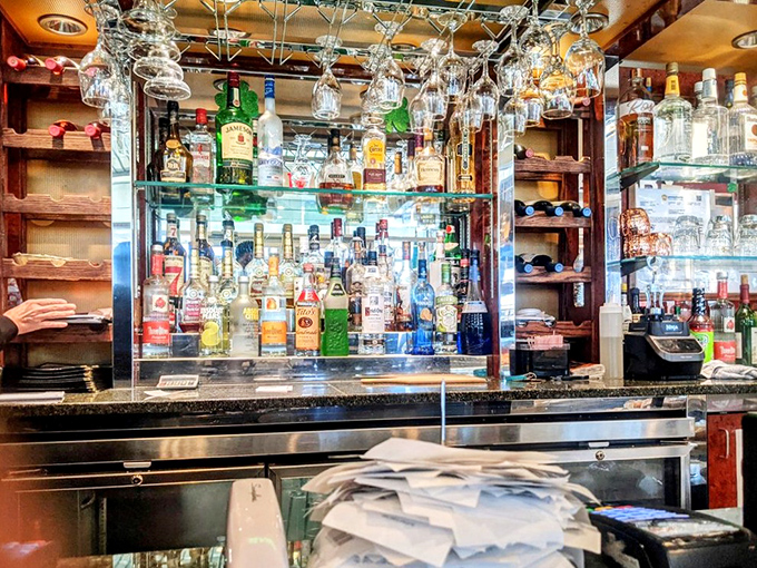 The bar where liquid courage meets comfort food cravings. Those hanging glasses are like crystal chandeliers in this cathedral of casual dining. 