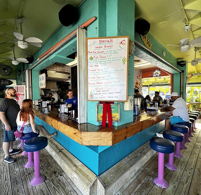 The heart of operations &ndash; vibrant turquoise walls, purple stools, and a specials board that changes with the tides.