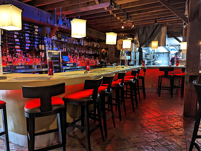 A bar that beckons with ruby-red lighting. The impressive spirits collection promises cocktail adventures for the curious palate.