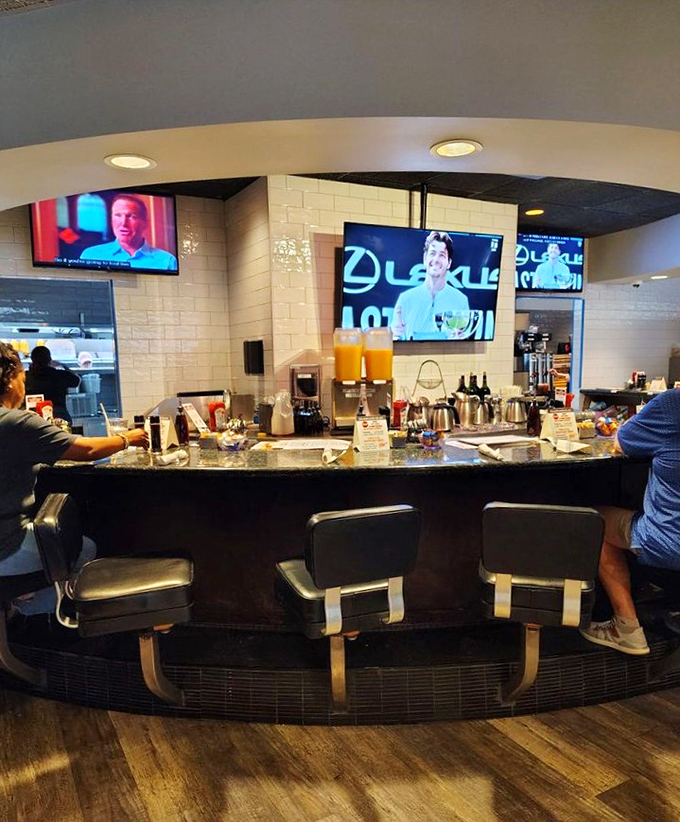 The bar counter&mdash;where morning mimosas meet coffee connoisseurs under the watchful eye of mounted TVs showing the day's events.
