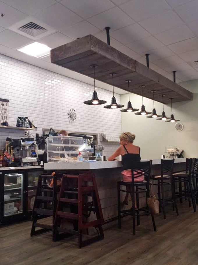 The counter offers front-row seats to the culinary action, where pendant lights dangle from a rustic beam overhead.