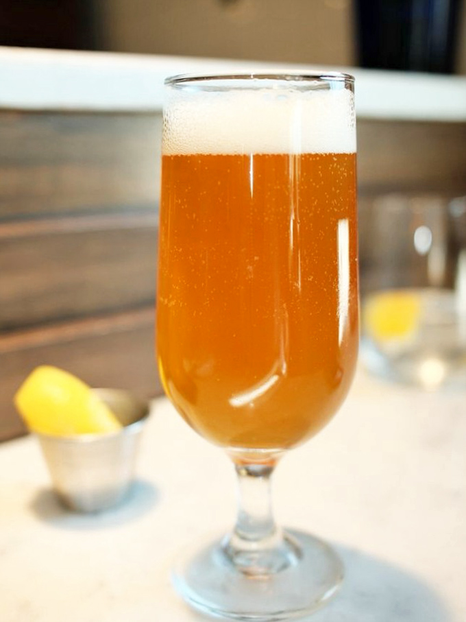 A golden chalice of beer that practically whispers, "You've earned this after all that difficult menu decision-making."