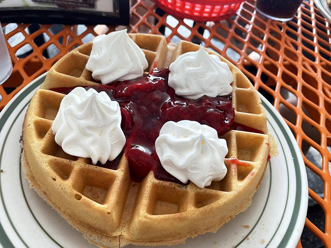 A waffle that's dressed for success with whipped cream dollops and berry compote. Breakfast or dessert? Why choose?