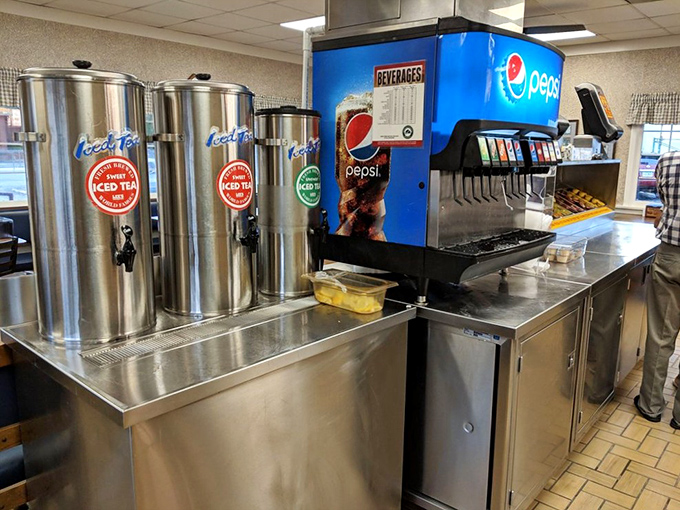 The beverage station stands ready for duty like hydration headquarters. Those tea dispensers have witnessed countless refills and "just one more" moments.