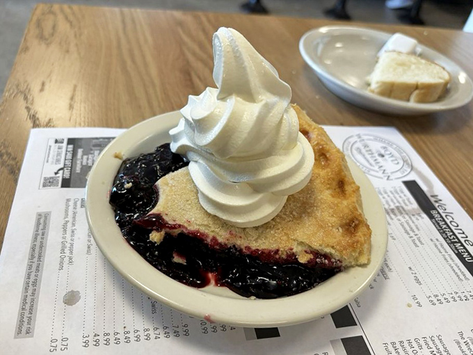Black raspberry pie topped with real whipped cream, the kind of dessert that stops conversations mid-sentence.