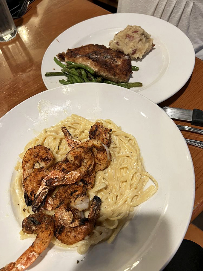Two plates that tell the story of Malone's versatility &ndash; blackened shrimp twirling through creamy pasta while fish keeps it classy upstairs.
