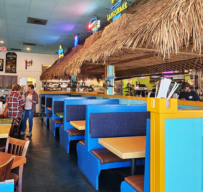 Tiki hut heaven! The straw-roofed dining area with vibrant blue booths creates a vacation vibe even on an ordinary Tuesday lunch break.