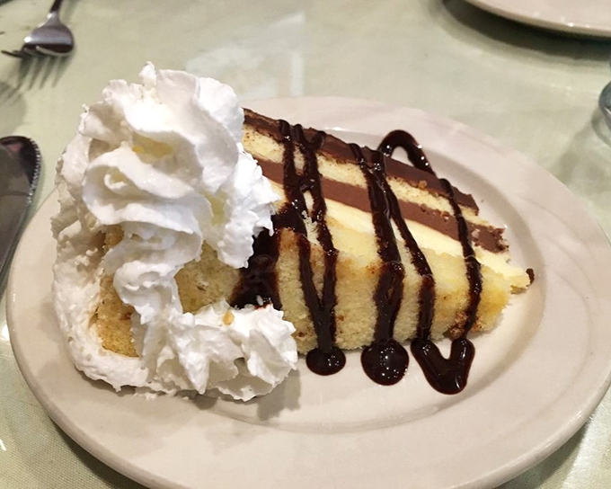 A slice of Boston cream cake that makes you wonder why we don't all just start with dessert. Life's uncertain—eat the cake first.