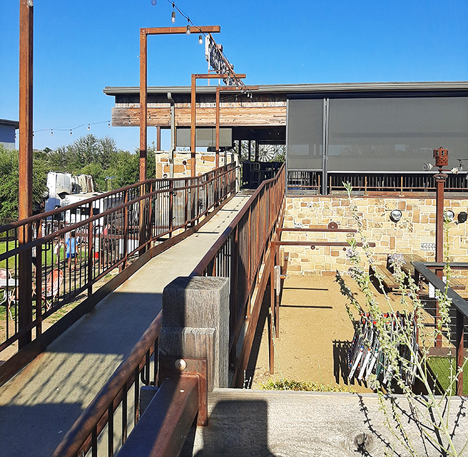 The museum's exterior features an elevated walkway, guiding visitors through additional outdoor exhibits and installations.