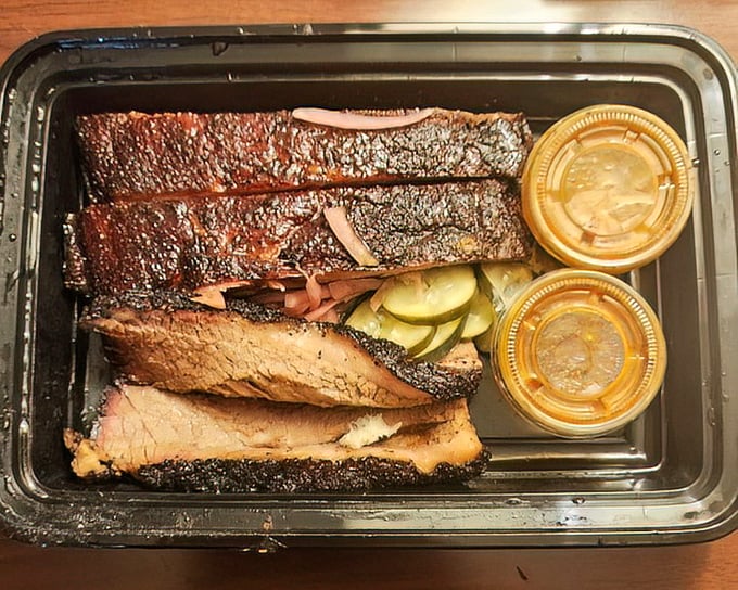 To-go packaging that respects the meat's dignity. Even in a plastic container, this brisket maintains its James Dean cool.