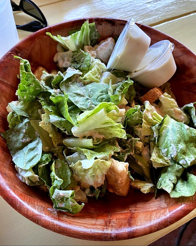 A Caesar salad that Julius himself would approve&mdash;crisp romaine dressed in creamy goodness, served in a wooden bowl that whispers "authenticity."