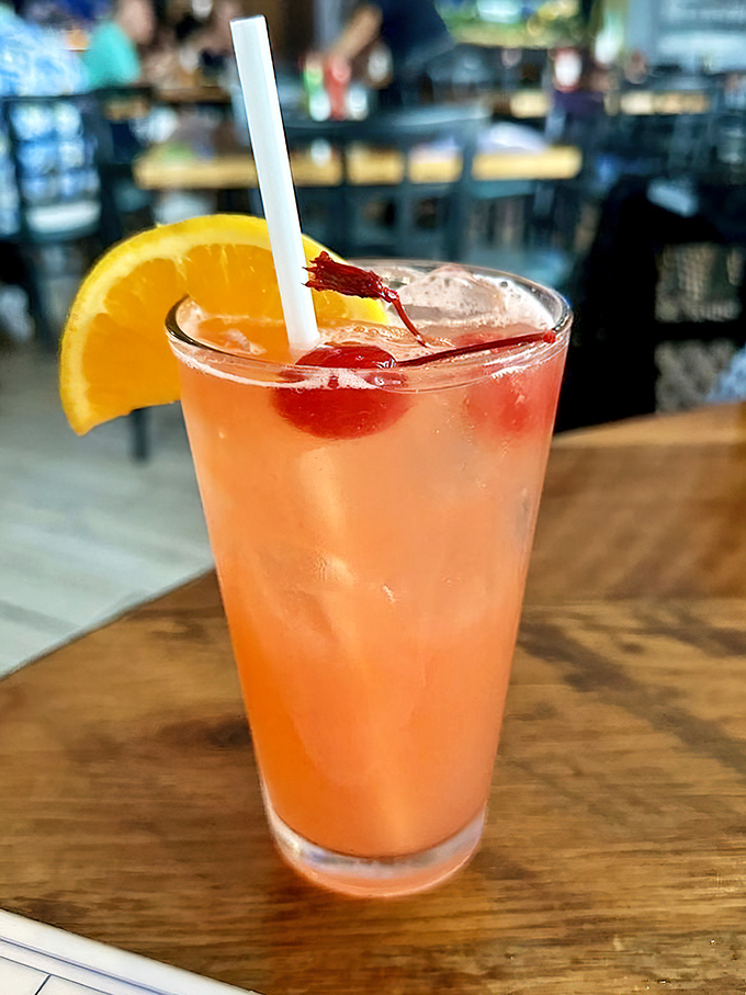 This isn't just a cocktail; it's liquid Florida sunshine in a glass, complete with the requisite tropical garnishes.