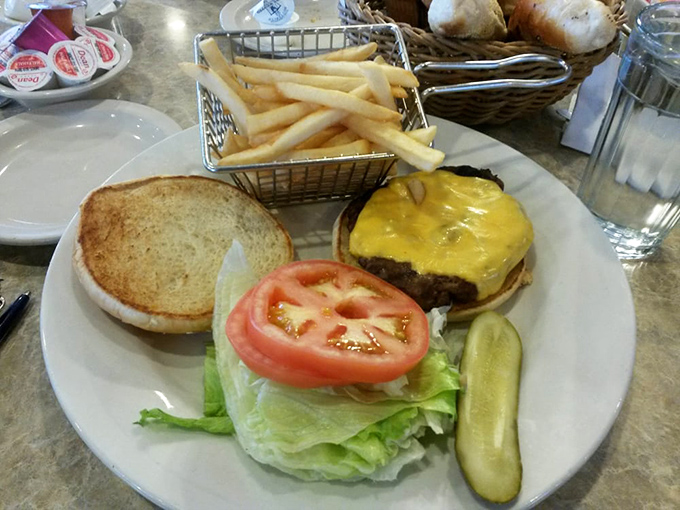 A cheeseburger that doesn't need Instagram filters &ndash; just napkins. The pickle standing guard ensures no bite is without that perfect tang.