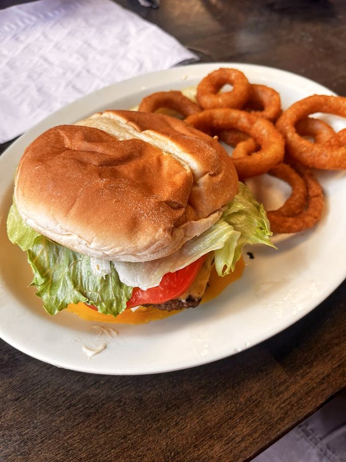 A classic American cheeseburger with onion rings&mdash;proof that simplicity, when done with conviction, beats complexity every time.
