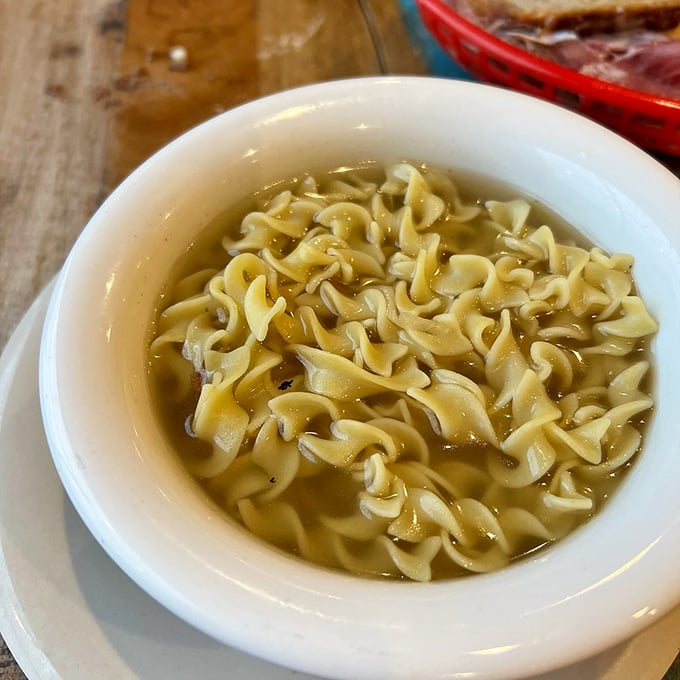 Egg noodles swimming in golden broth like synchronized swimmers performing the world's most comforting routine. Soul-warming in a bowl.