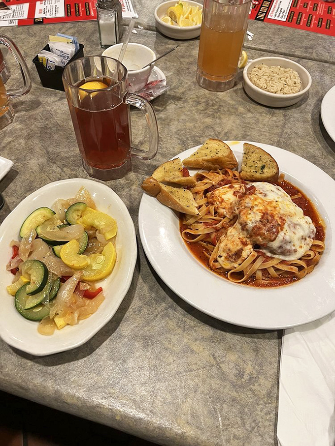 Italian-American comfort meets Maryland hospitality: chicken parmesan with pasta and garlic bread, with a cold beer standing by for moral support.
