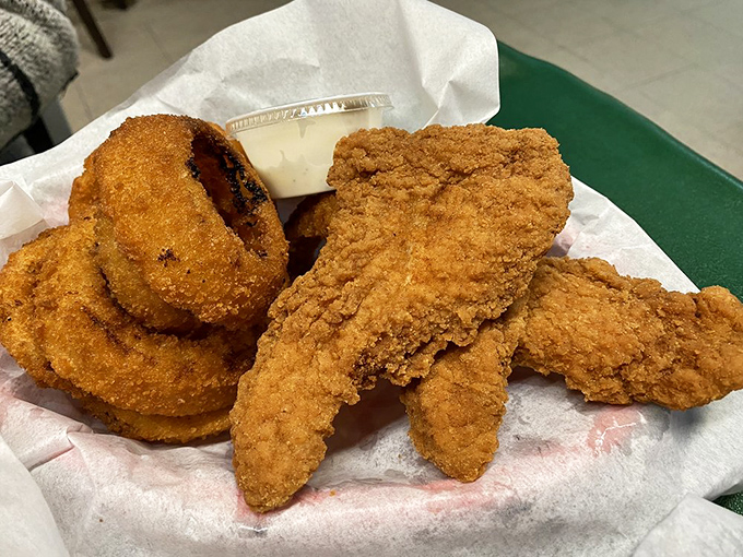 Golden-fried chicken tenders and onion rings &ndash; proof that sometimes the simplest pleasures are the most satisfying, especially when the breading is this perfect.