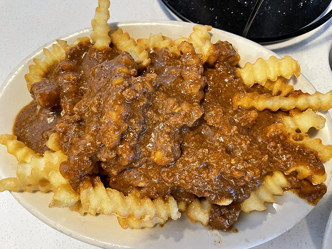 Chili fries that laugh in the face of utensils&mdash;a glorious mess that demands to be tackled with equal parts strategy and abandon.